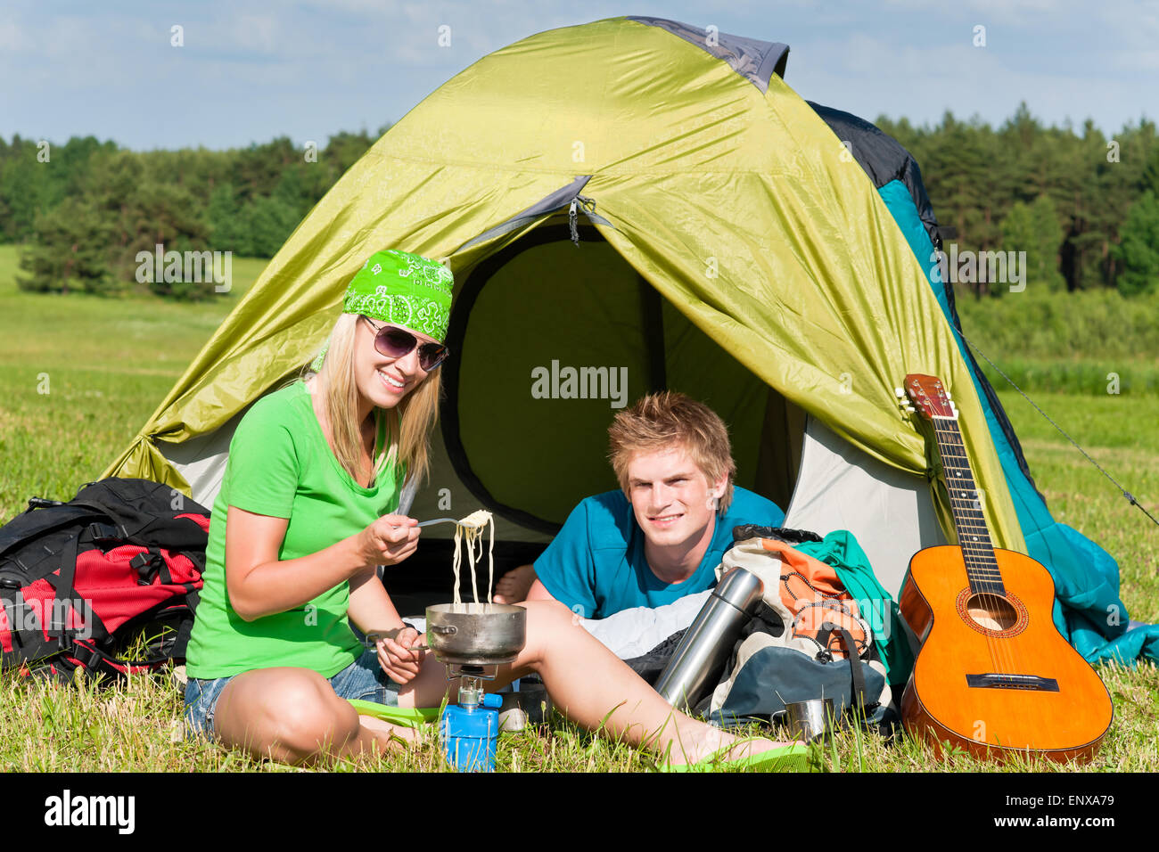 Young camping couple cooking meal outside tent Stock Photo - Alamy