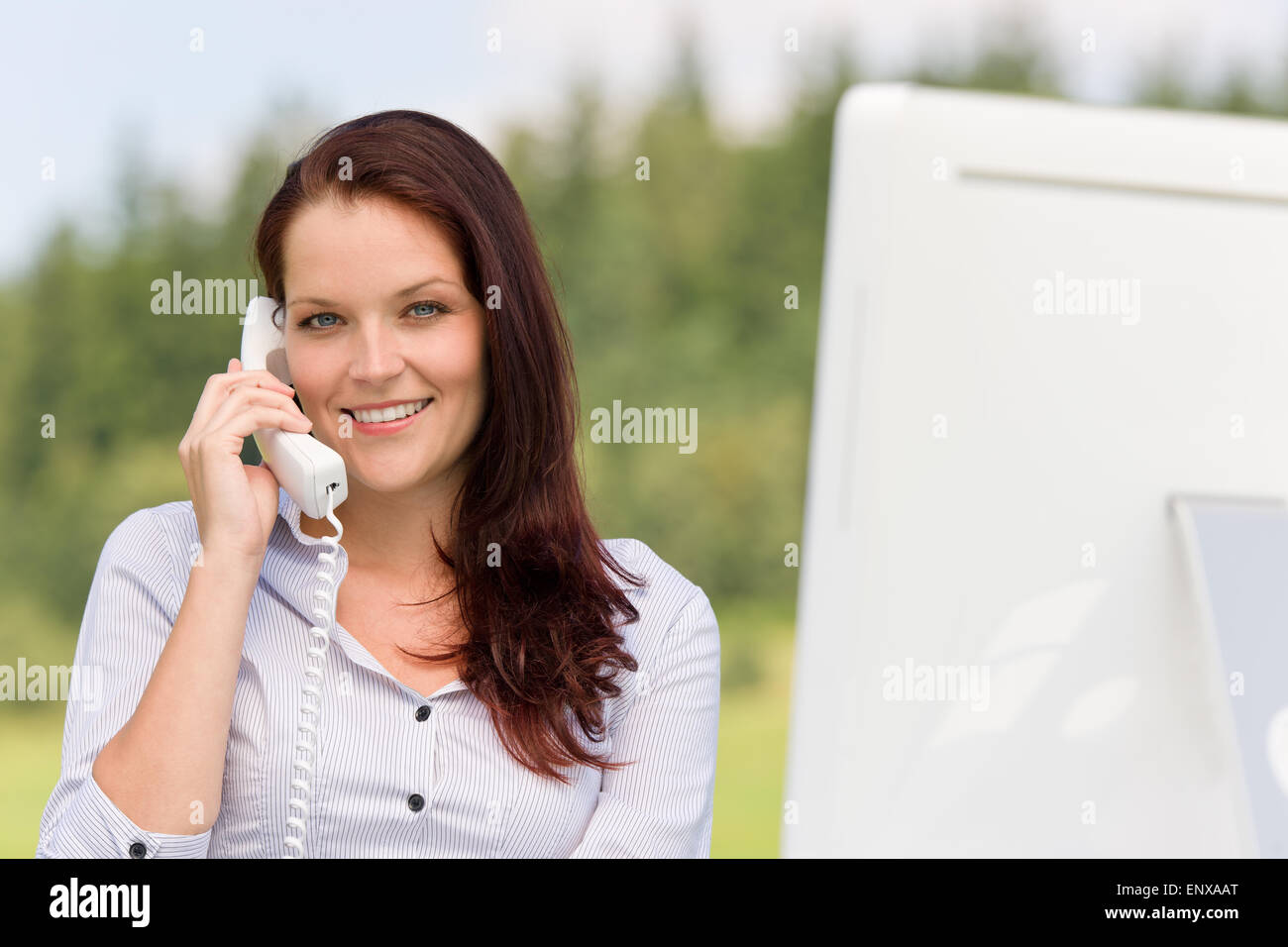 Businesswoman in nature attractive smile calling Stock Photo - Alamy
