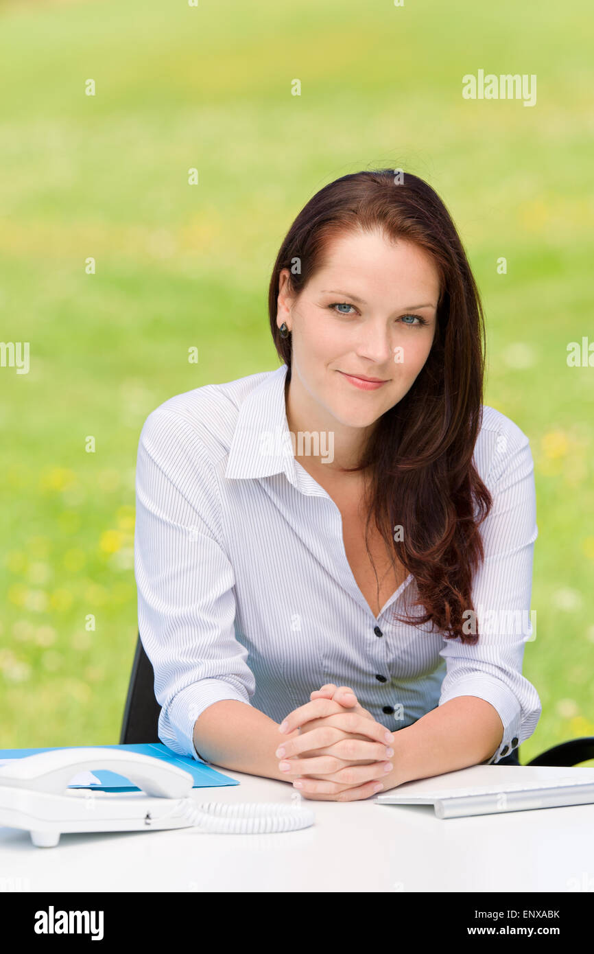 Businesswoman in nature attractive behind table Stock Photo - Alamy