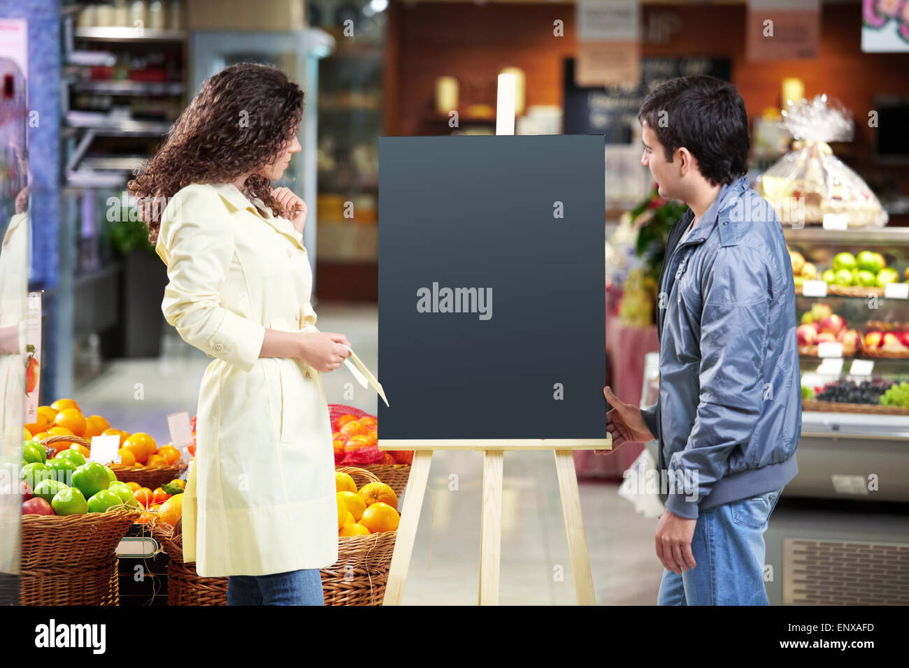 The man and the woman look at an empty board in shop Stock Photo - Alamy