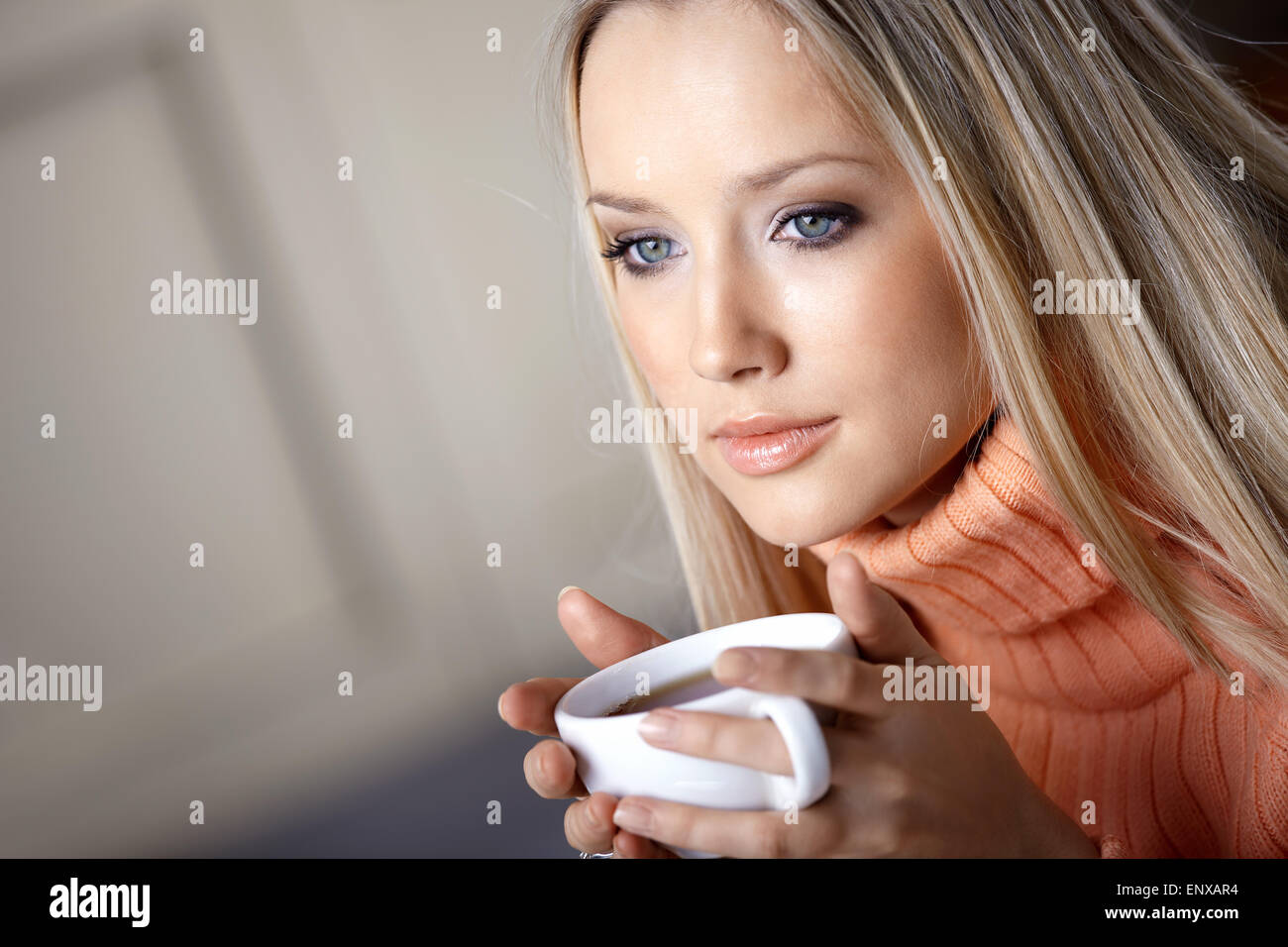 The attractive young girl with a cup close up Stock Photo - Alamy