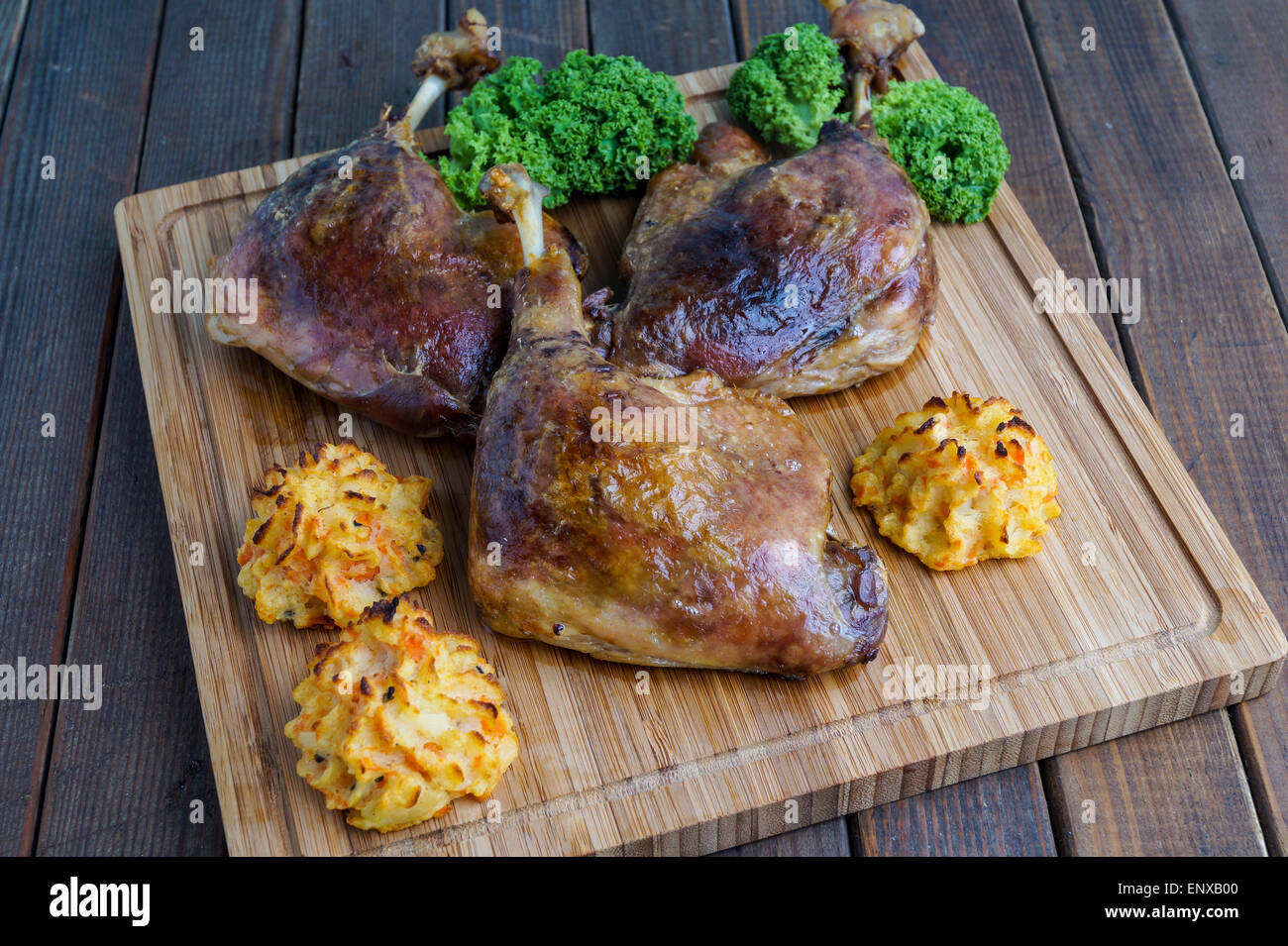 crispy duck leg served with baked potatoes Stock Photo - Alamy