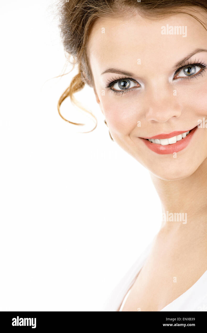 The portrait of smiling young woman isolated on a white background ...