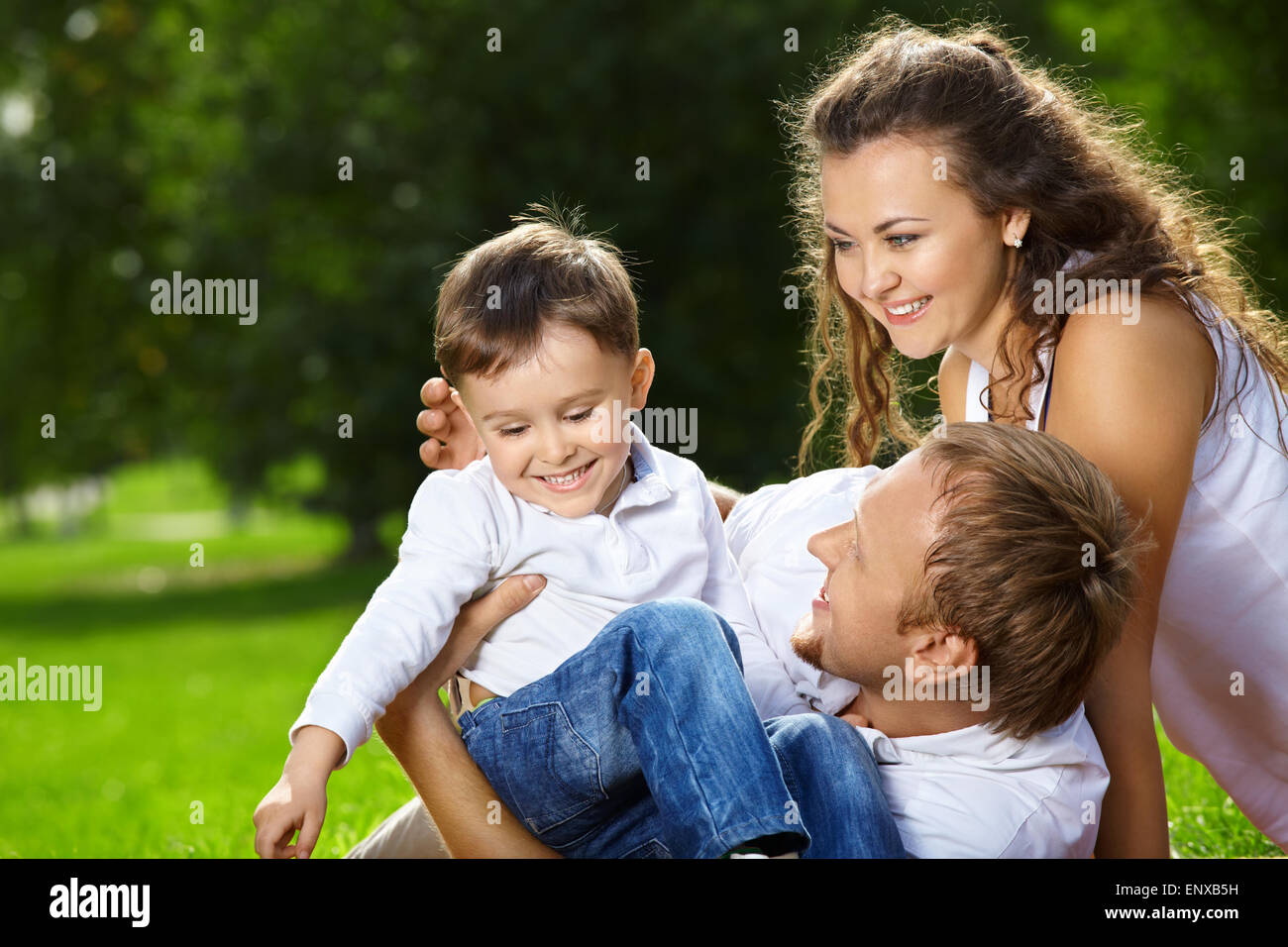 Two parents and their small son have a rest in a summer garden Stock ...