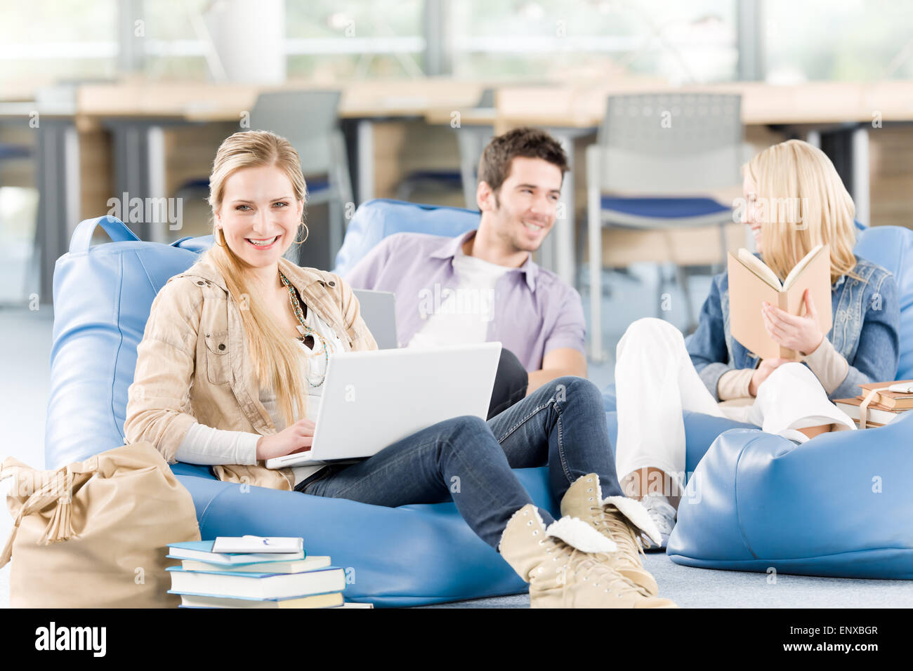 Group of high-school students with books sitting Stock Photo - Alamy