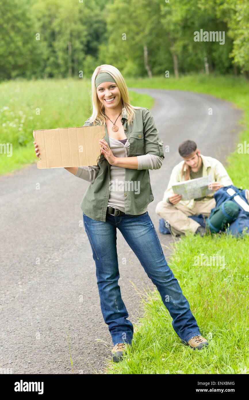 Hitch-hiking young couple backpack asphalt road Stock Photo - Alamy