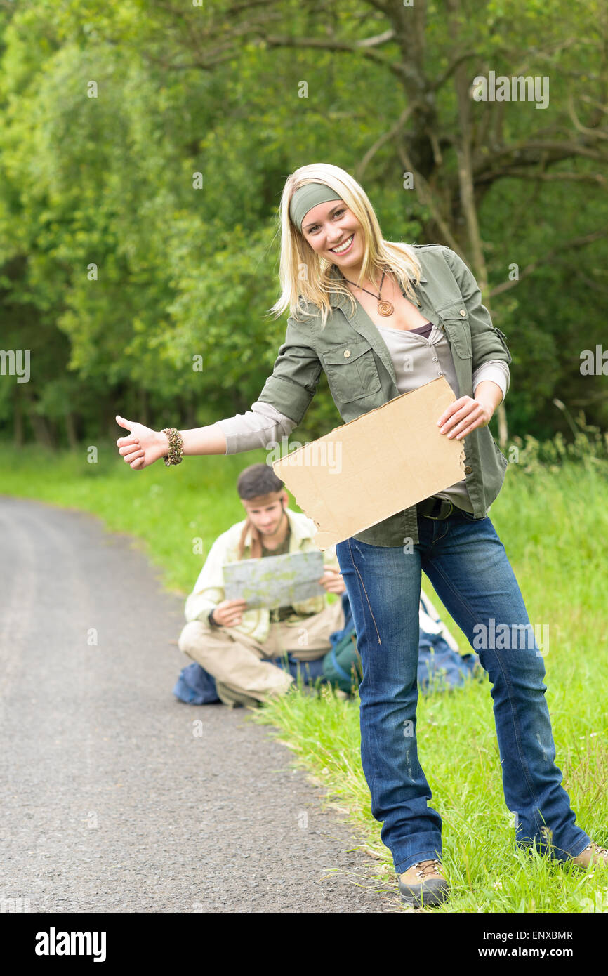 Hitch-hiking young couple backpack asphalt road Stock Photo - Alamy