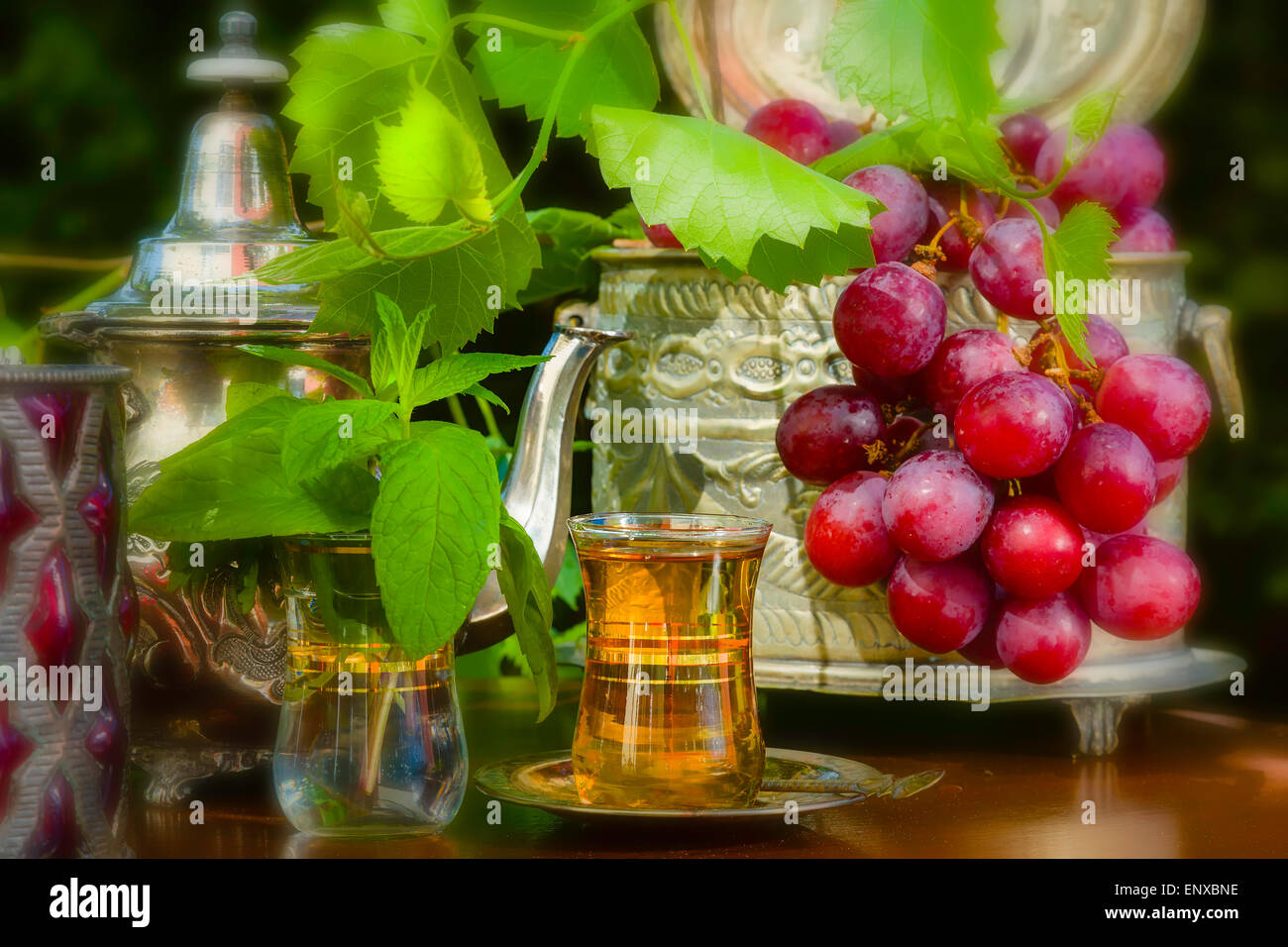 Mint tea and red grapes on Arabian table in the garden Stock Photo - Alamy