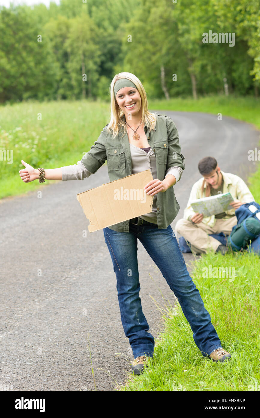 Hitch-hiking young couple backpack asphalt road Stock Photo - Alamy