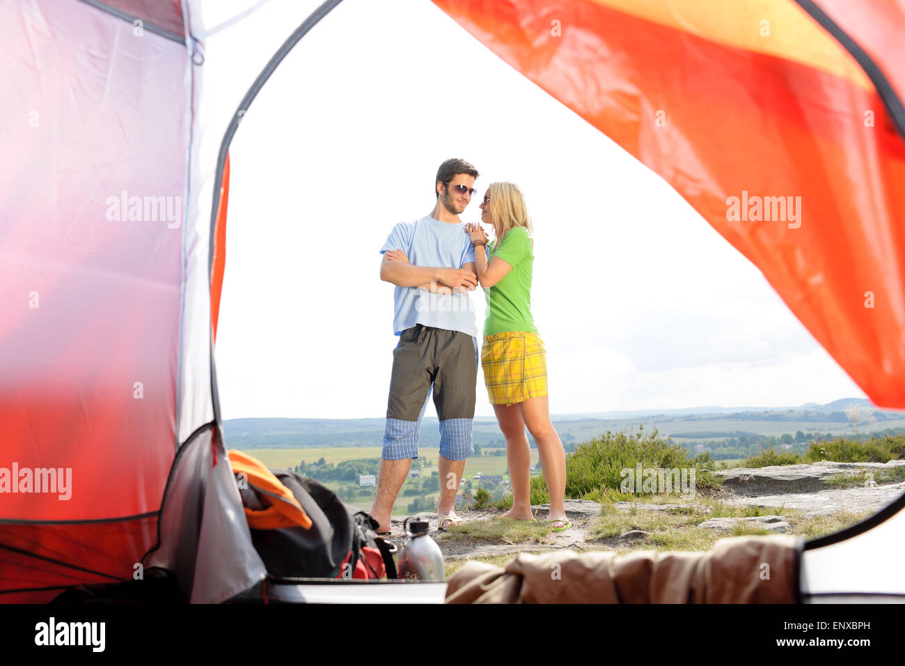 Camping young couple outside tent panoramic view Stock Photo - Alamy