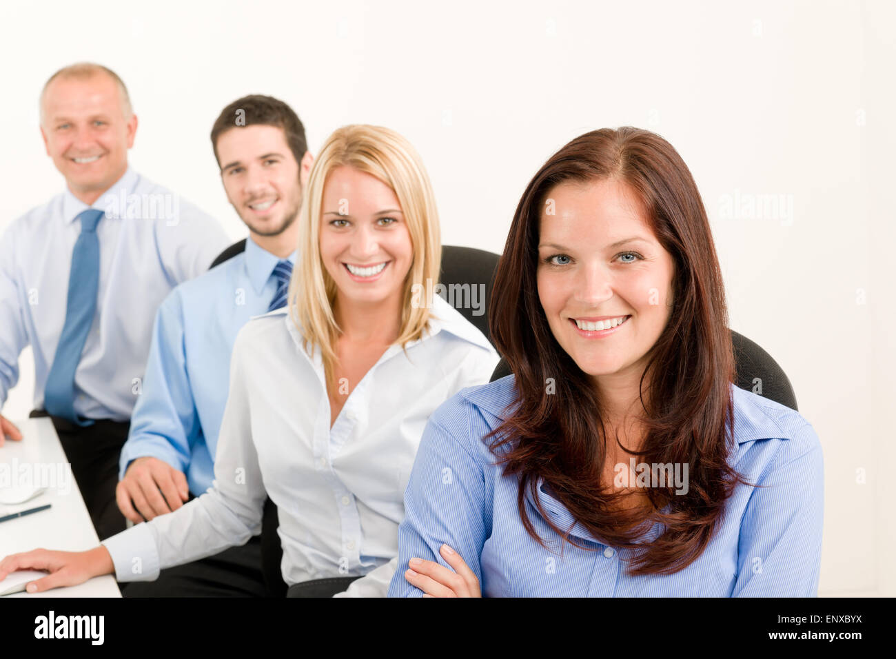 Business team happy sit in line behind table Stock Photo - Alamy