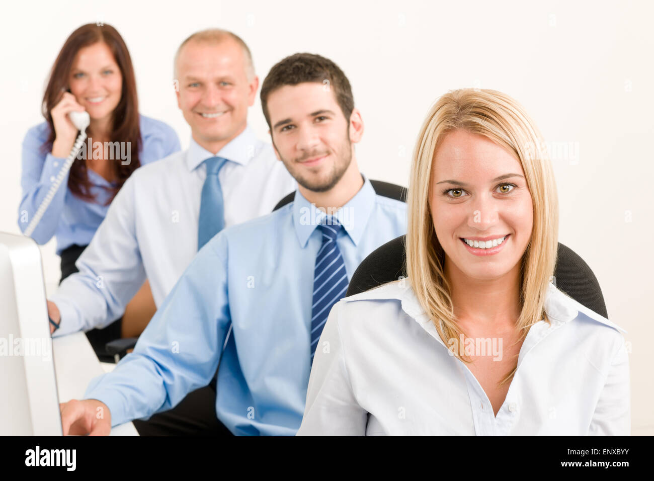 Business team happy sit in line behind table Stock Photo - Alamy
