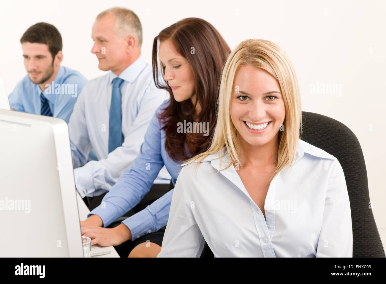 Business team happy sit in line behind table Stock Photo - Alamy