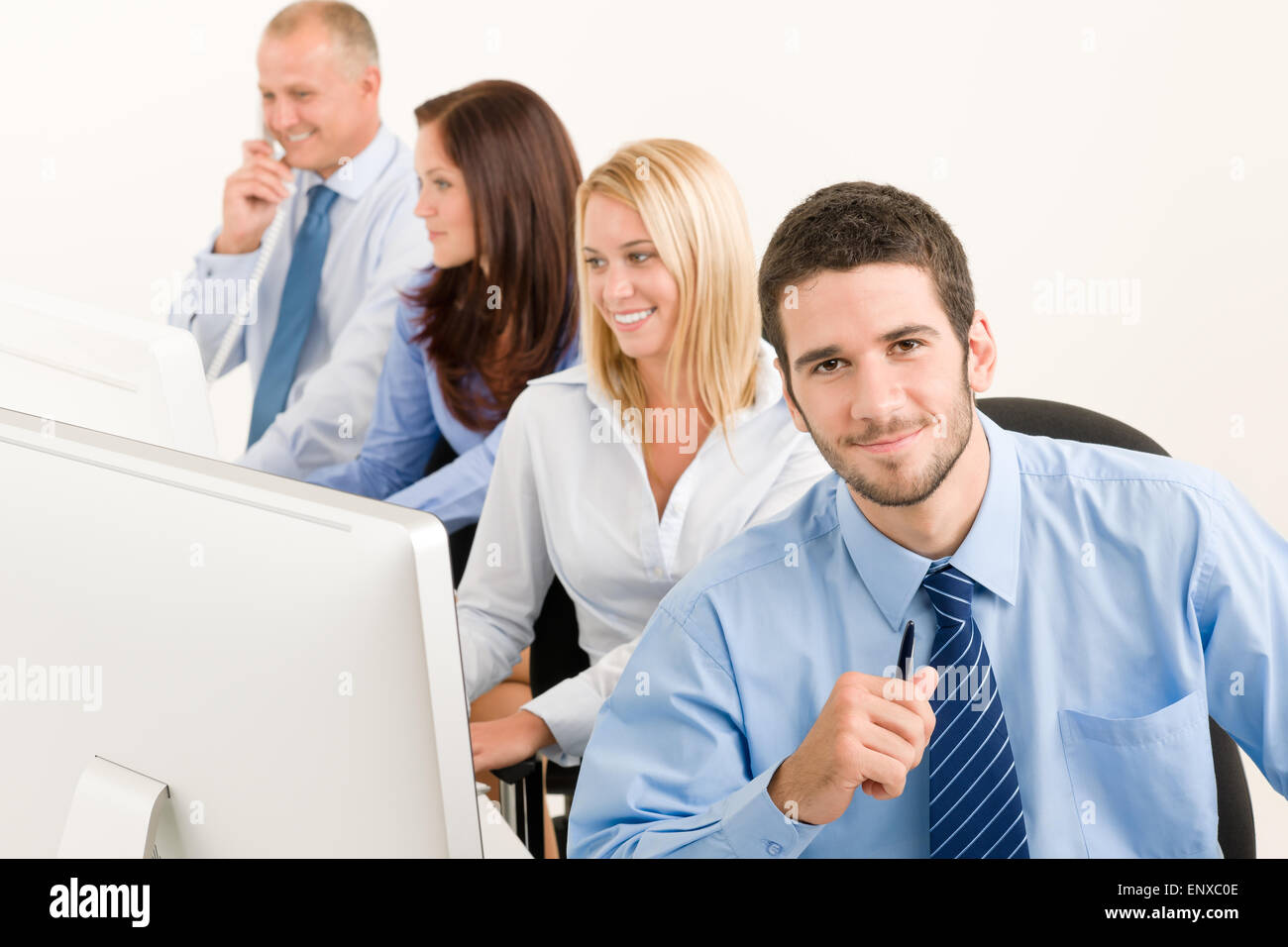 Business team happy sit in line behind table Stock Photo - Alamy