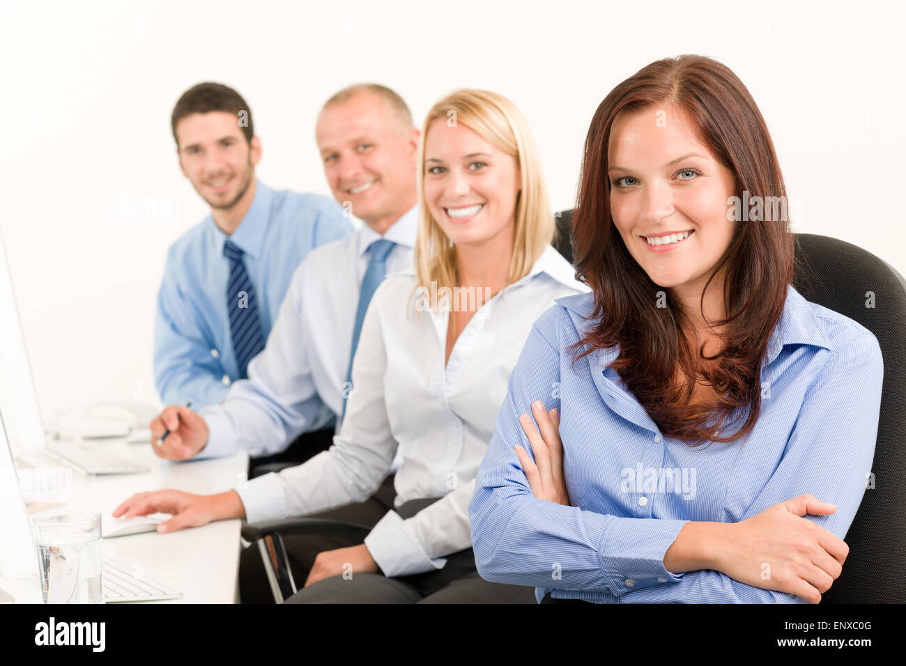 Business team happy sit in line behind table Stock Photo - Alamy
