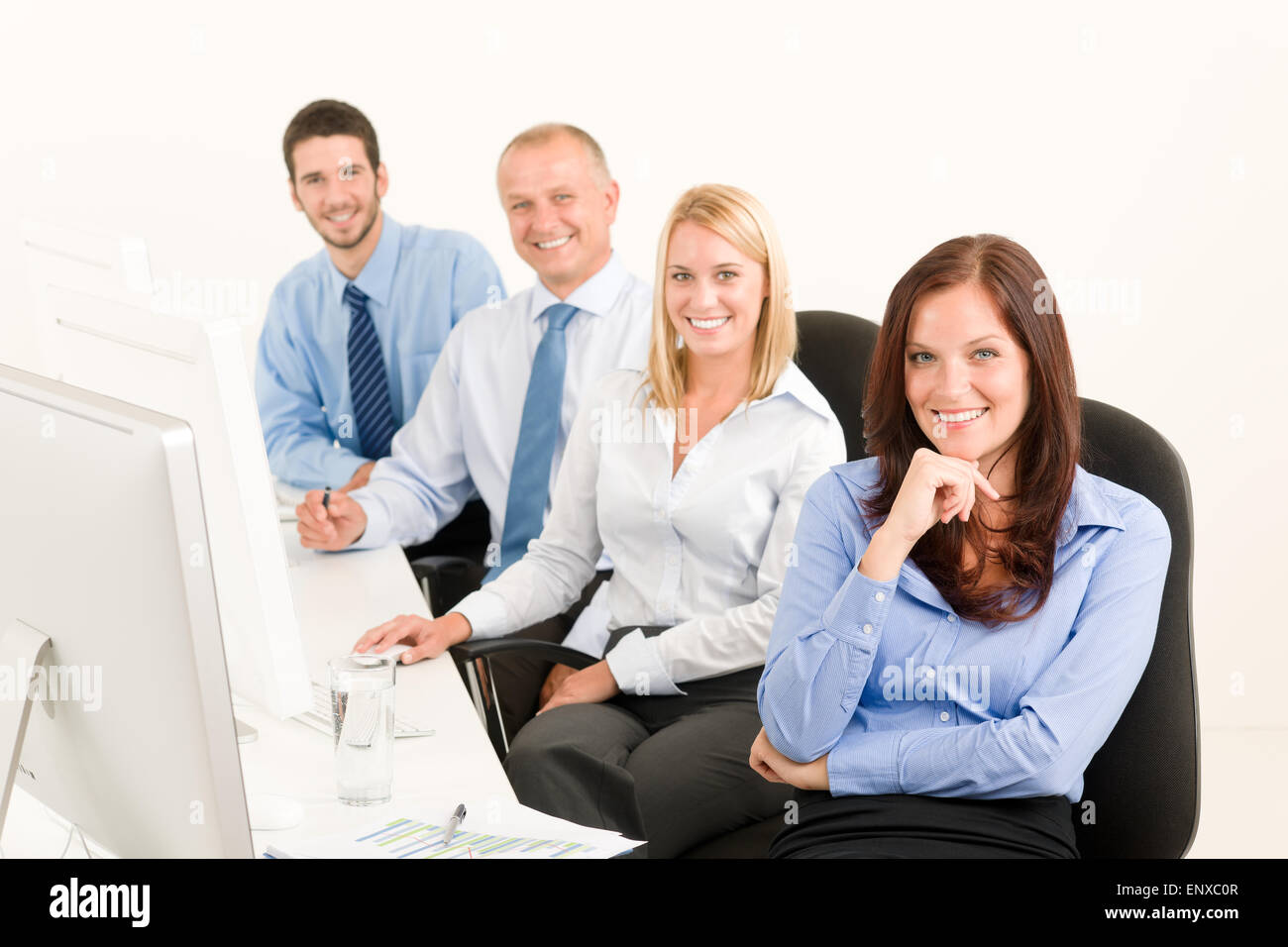 Business team happy sit in line behind table Stock Photo - Alamy