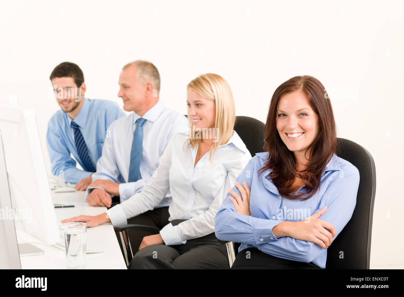 Business team happy sit in line behind table Stock Photo - Alamy