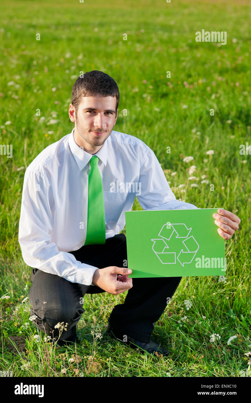 Green energy young businessman hold recycling sign Stock Photo - Alamy