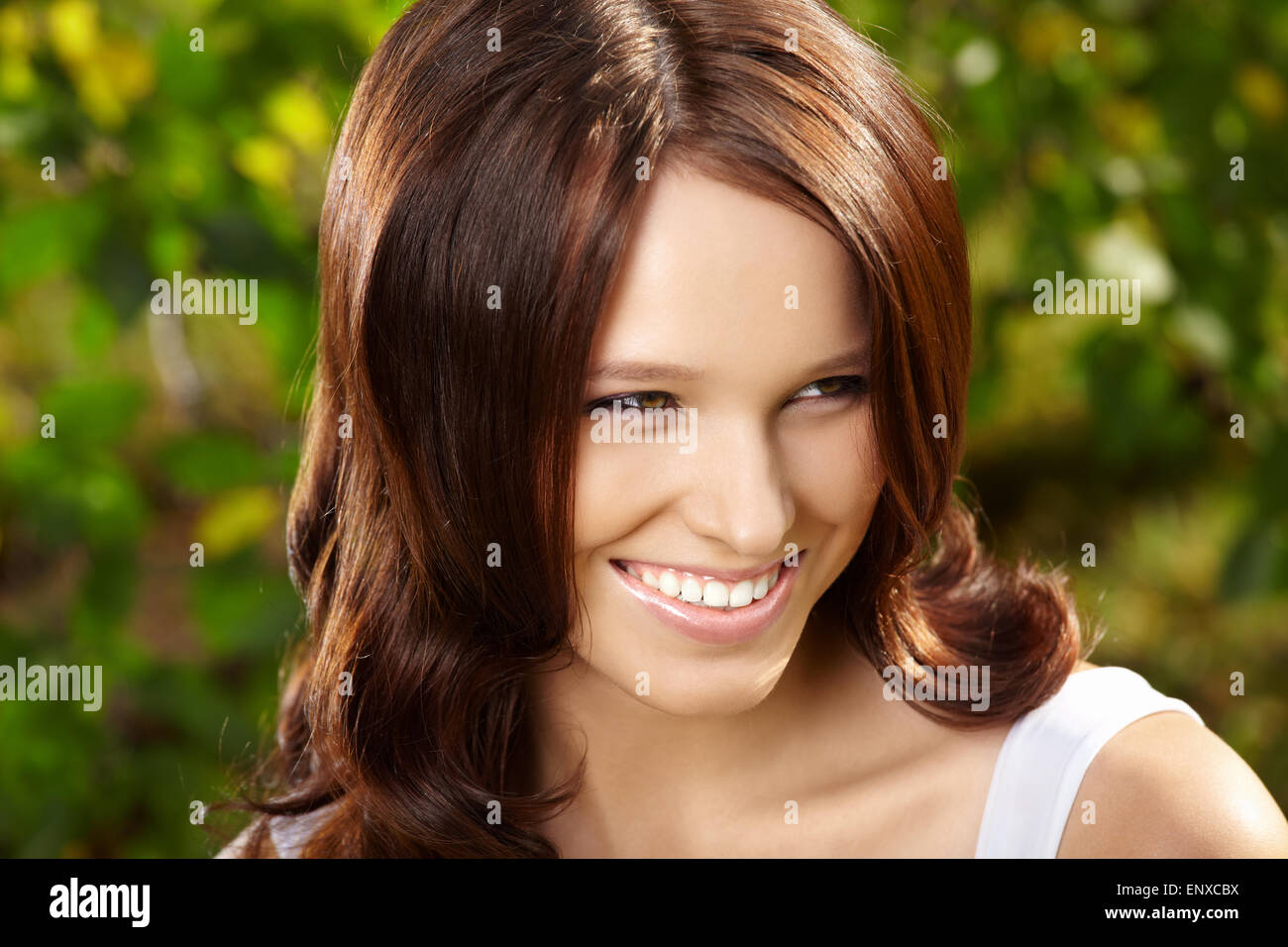 Delightful beauty with curly hair against magnificent vegetation Stock ...