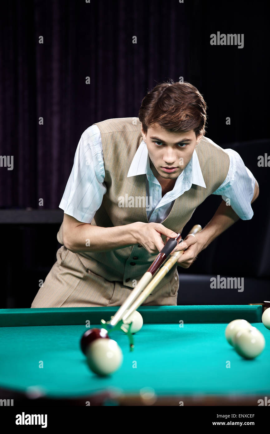The young attractive well dressed man plays billiards Stock Photo - Alamy