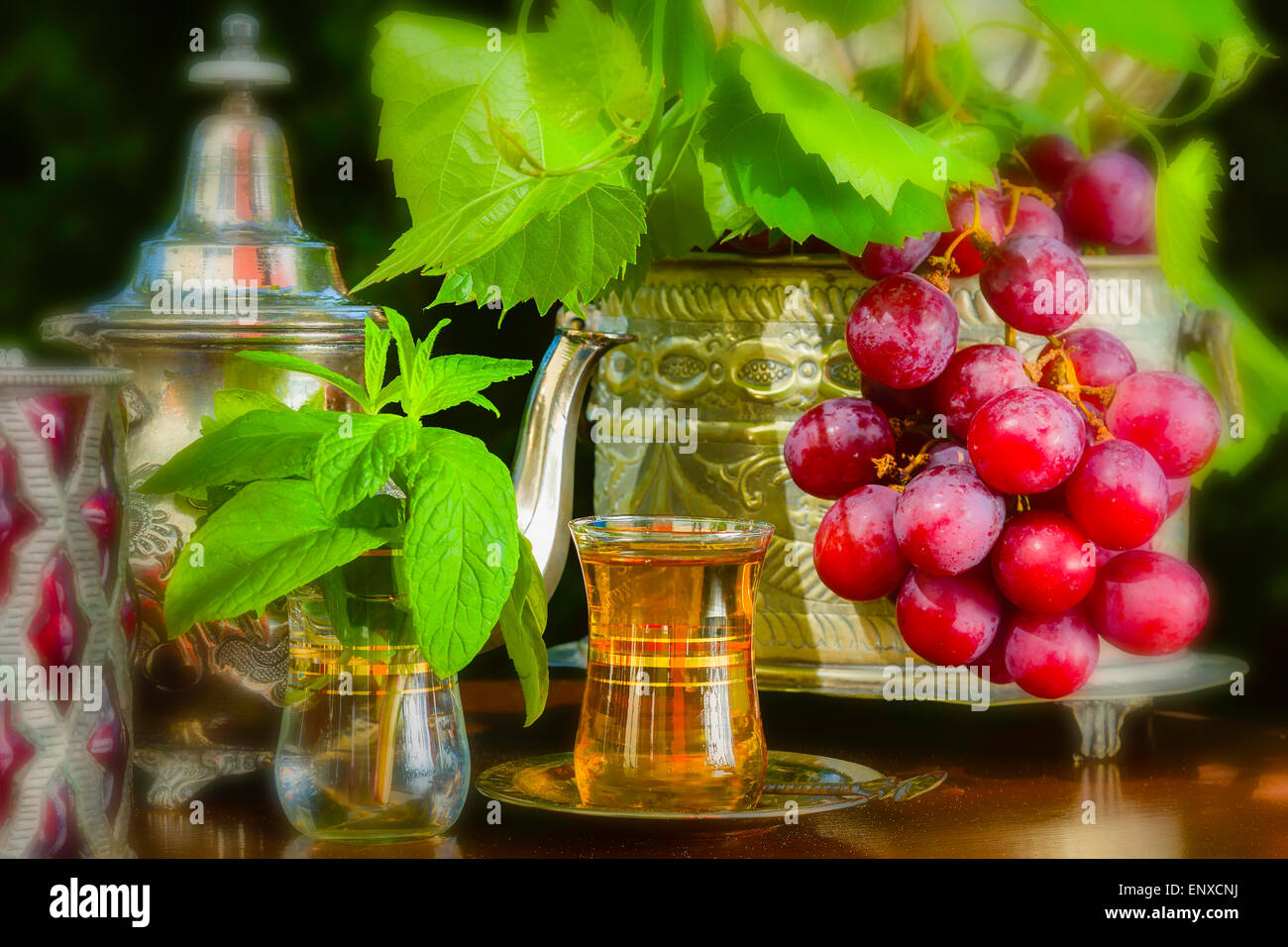 Mint tea and red grapes on Arabian table in the garden Stock Photo - Alamy