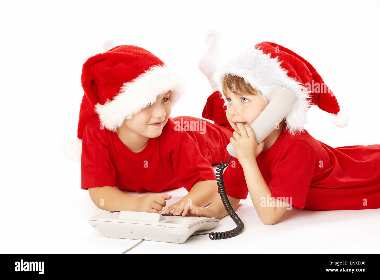 Two little boys in caps santa call by phone Stock Photo - Alamy
