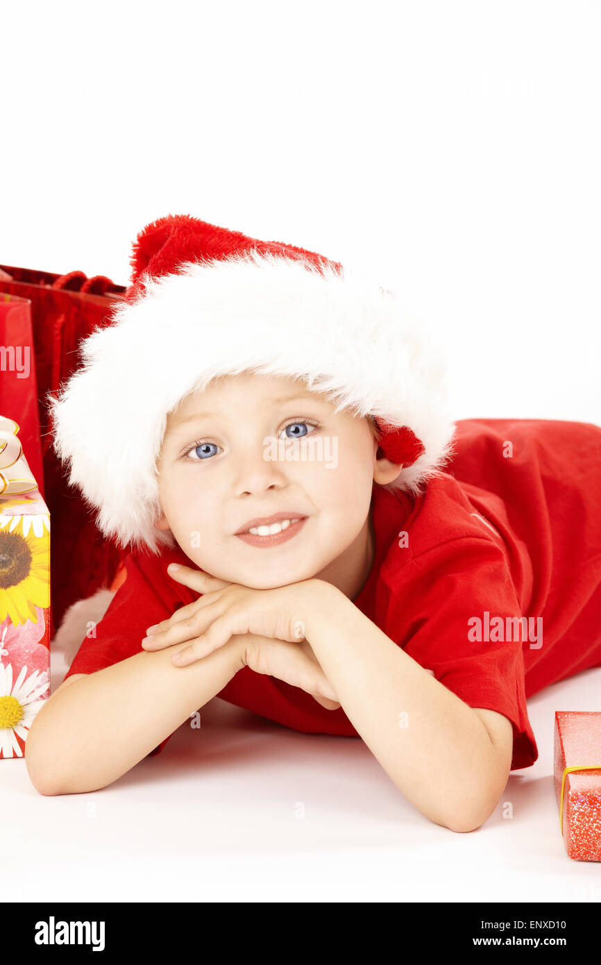 Portrait of little boy in a cap santa with gifts Stock Photo - Alamy