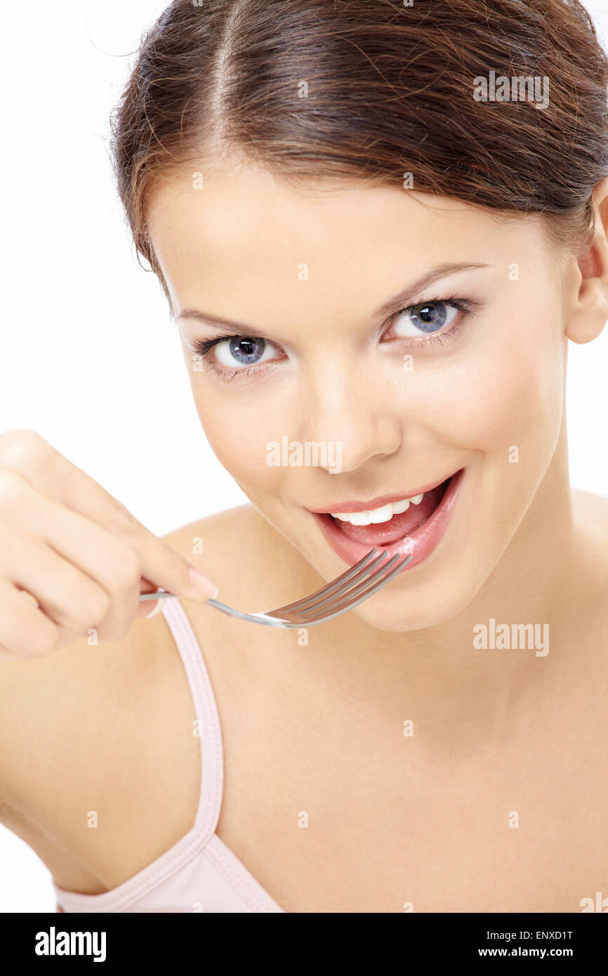 Portrait of girl eating something from a spoon Stock Photo - Alamy