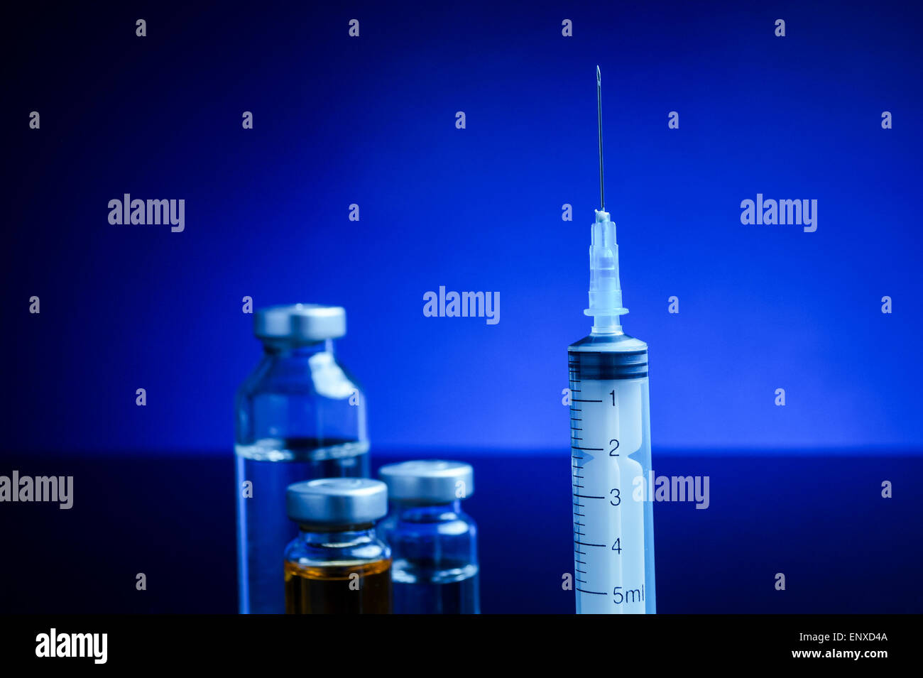 Syringe and medical vials, upright standing, isolated with background ...