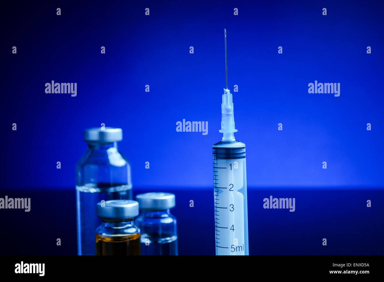 Syringe and medical vials, upright standing, isolated with background ...