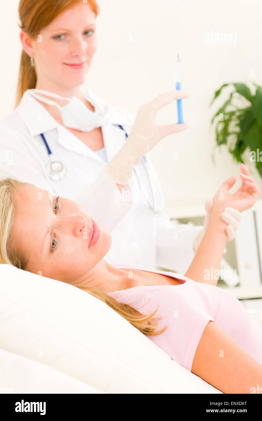 Medical doctor apply injection to woman patient Stock Photo - Alamy