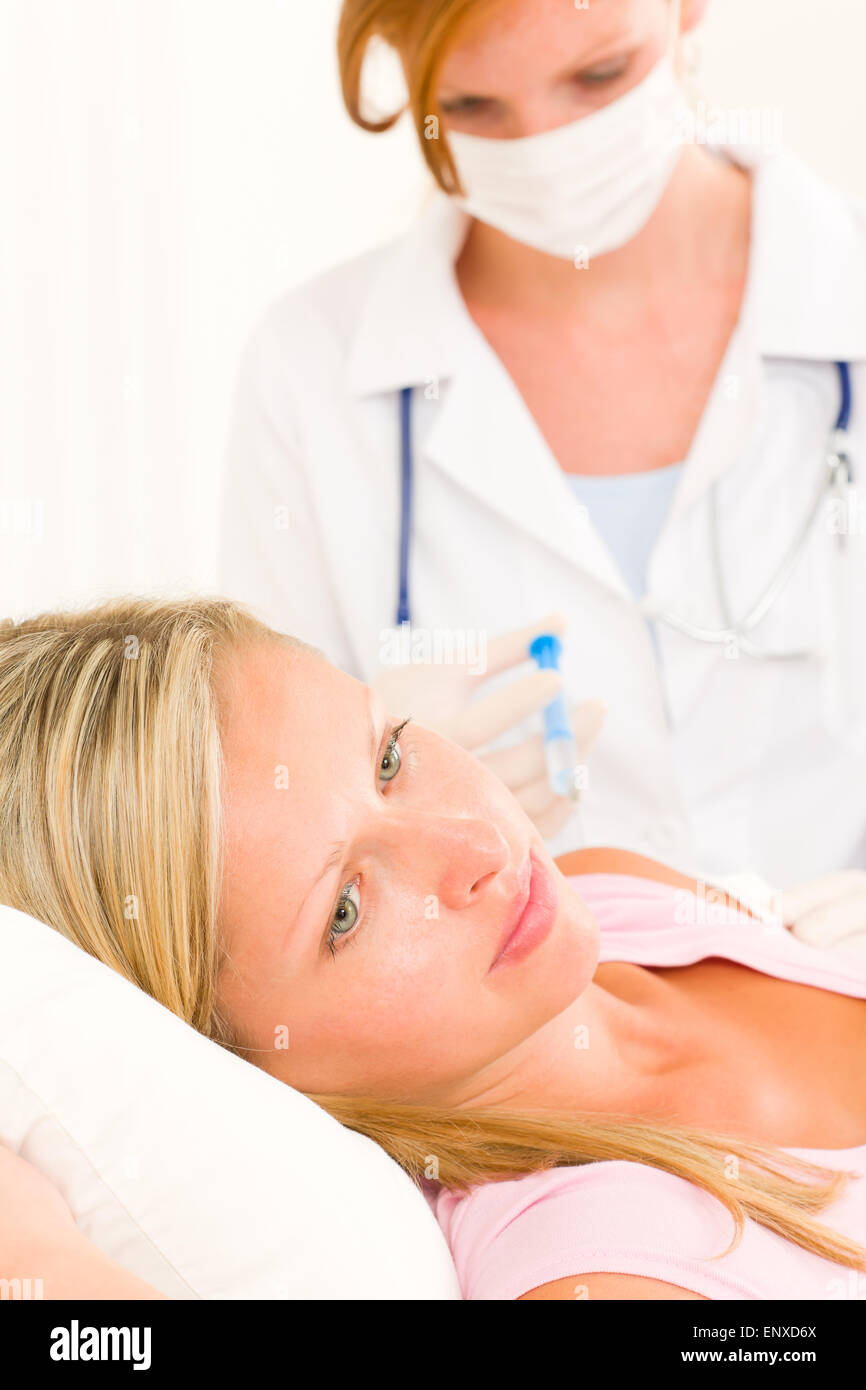 Medical doctor apply injection to woman patient Stock Photo - Alamy