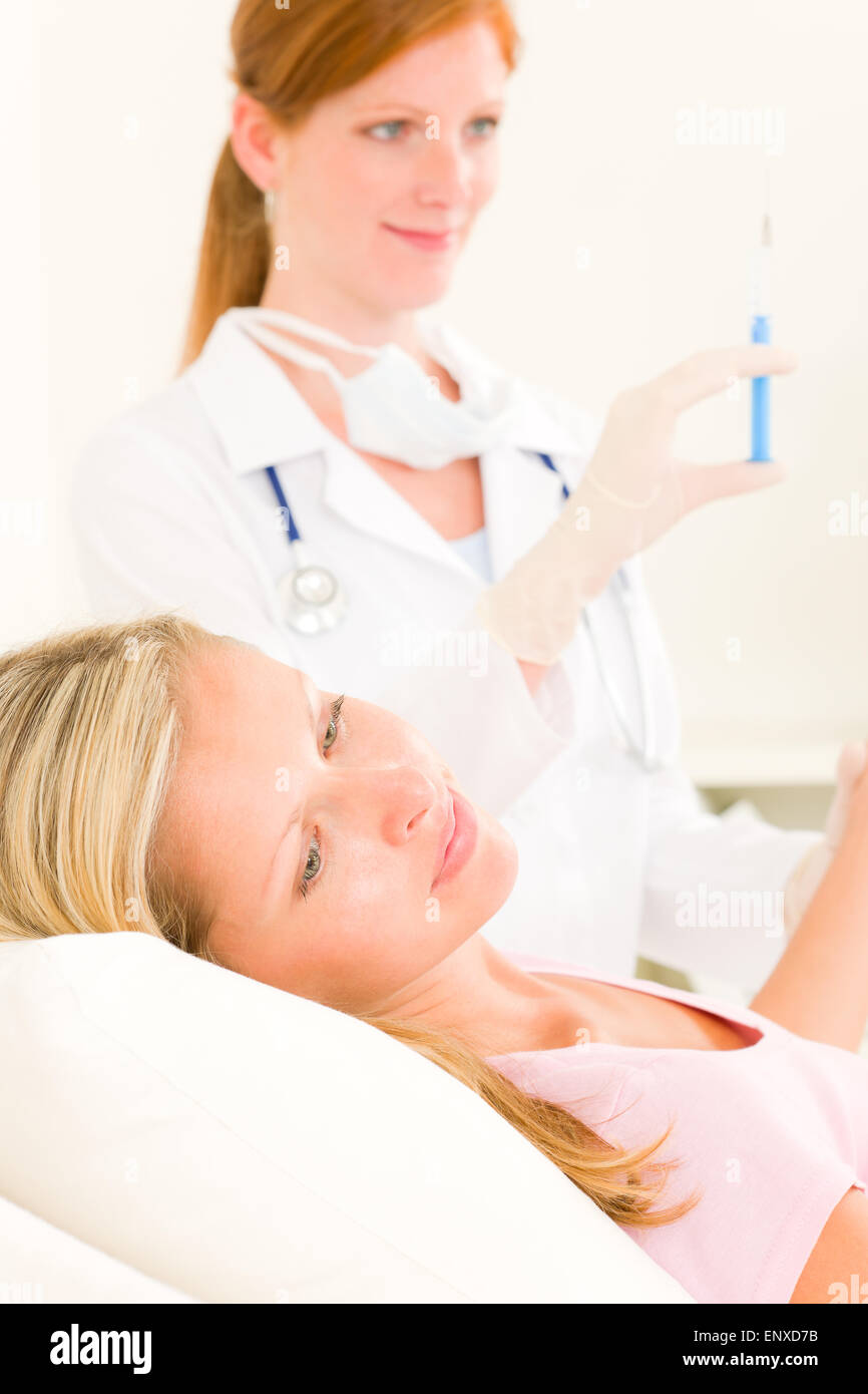 Medical doctor apply injection to woman patient Stock Photo - Alamy