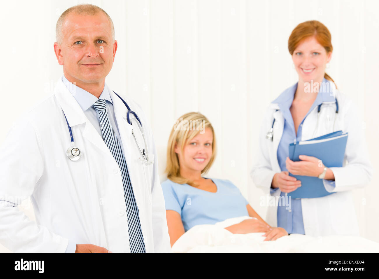 Medical doctors with hospital patient lying bed Stock Photo - Alamy
