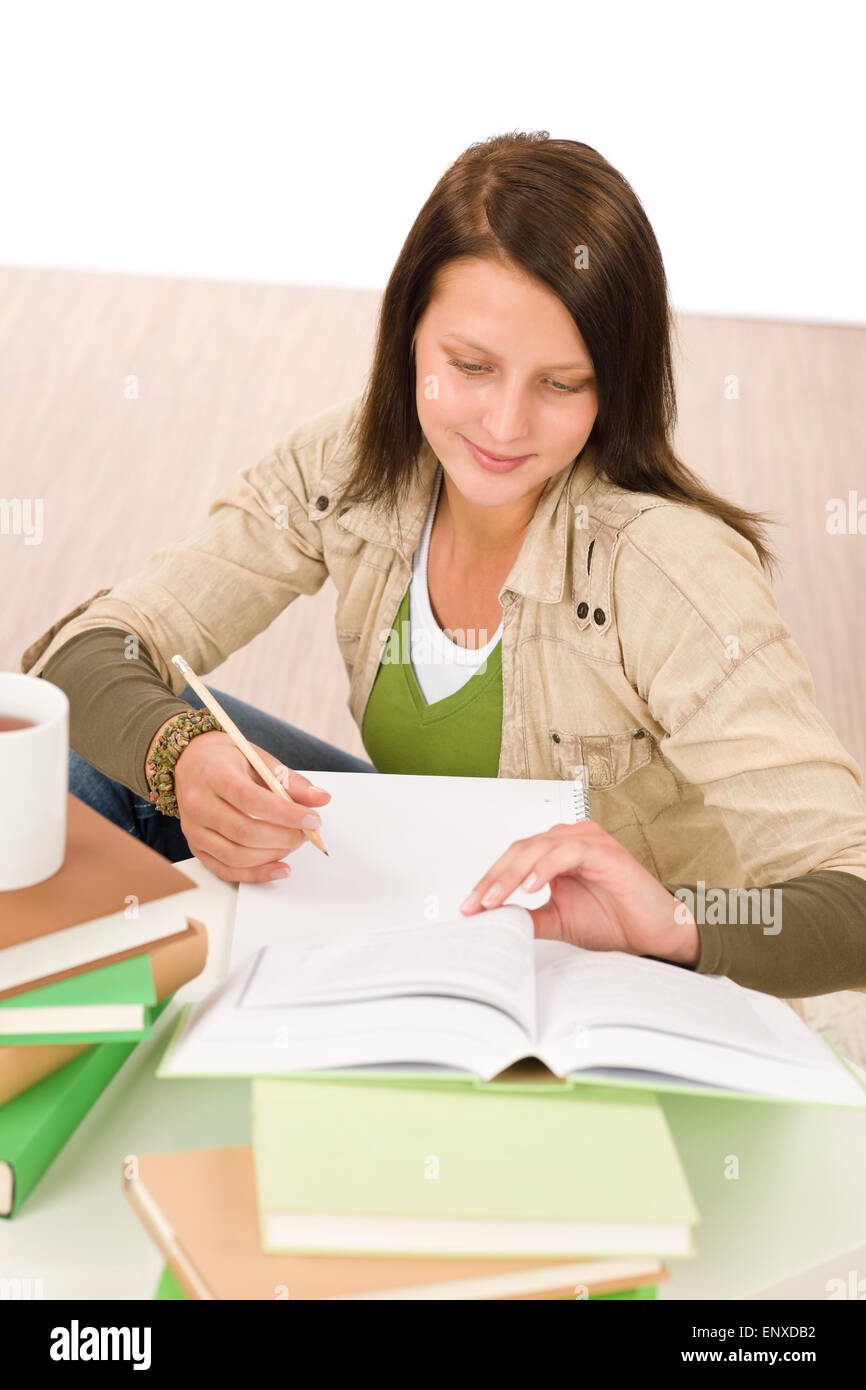 Student teenager girl write homework with book Stock Photo - Alamy