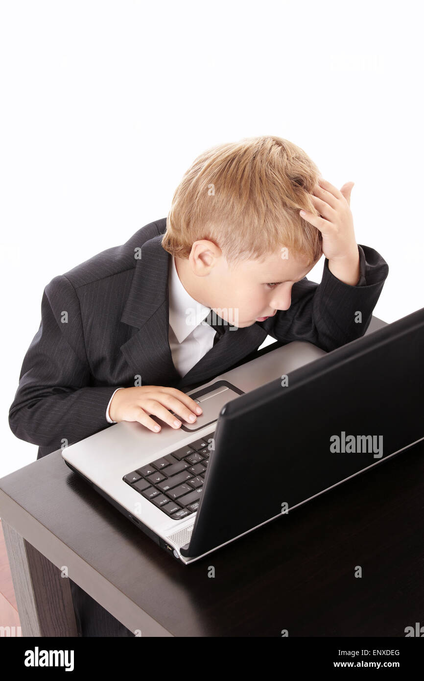Little boy in a business suit with the laptop in the confusion Stock ...