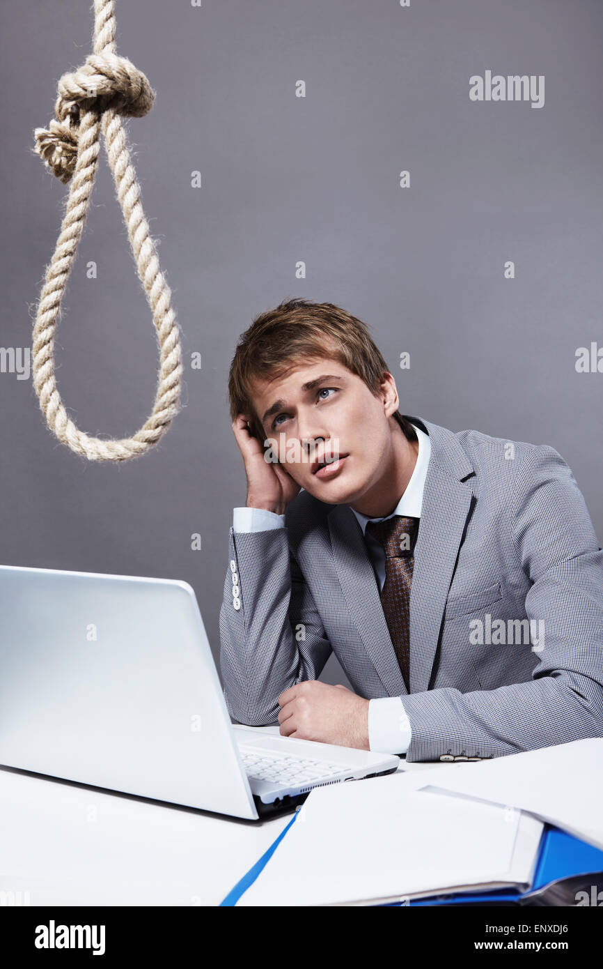 A young businessman looking at a loop in the workplace Stock Photo - Alamy