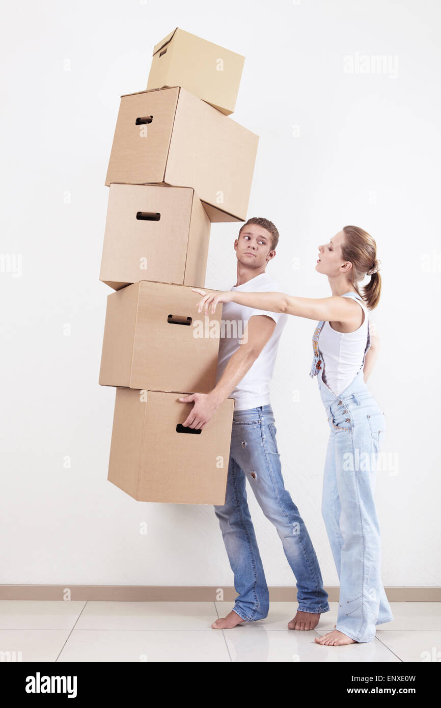 A young girl shows a man where to put the box Stock Photo - Alamy