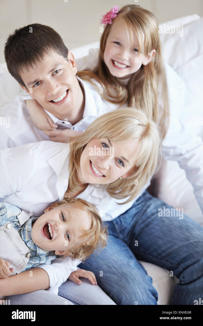 A happy family with two children on the couch Stock Photo - Alamy