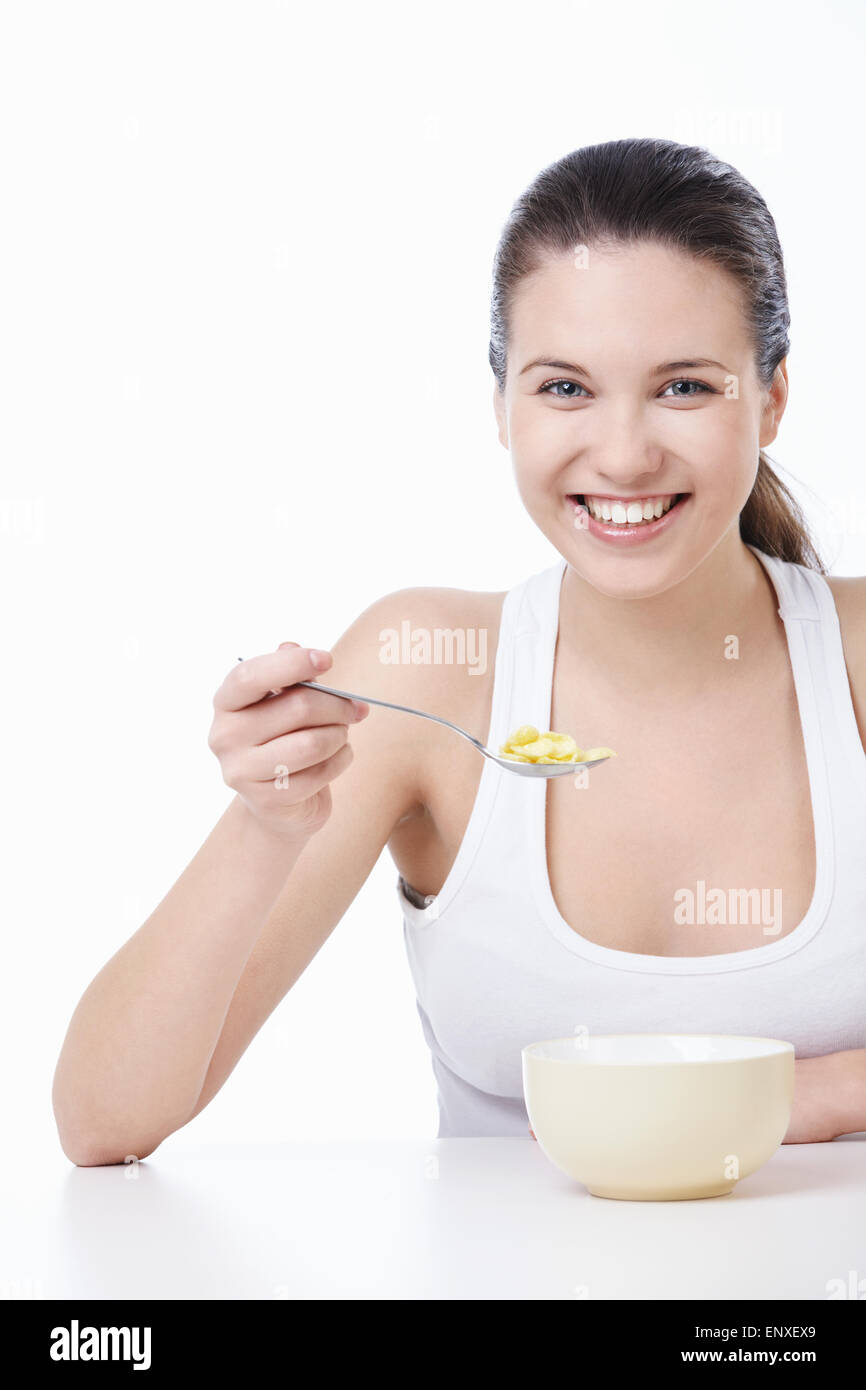A pretty young girl has corn flakes on a white background Stock Photo ...