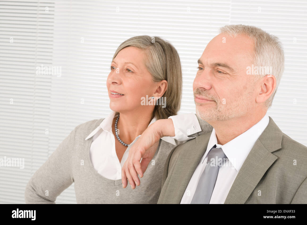 Senior businesspeople lean over shoulder colleague Stock Photo - Alamy