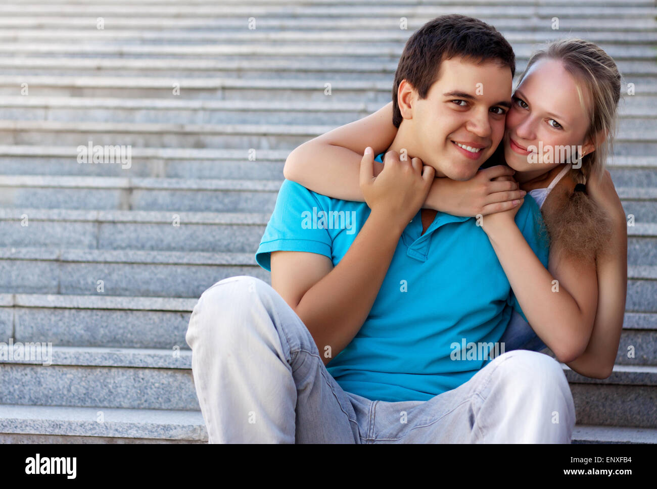 young loving couple sitting on stairs and embrace Stock Photo - Alamy