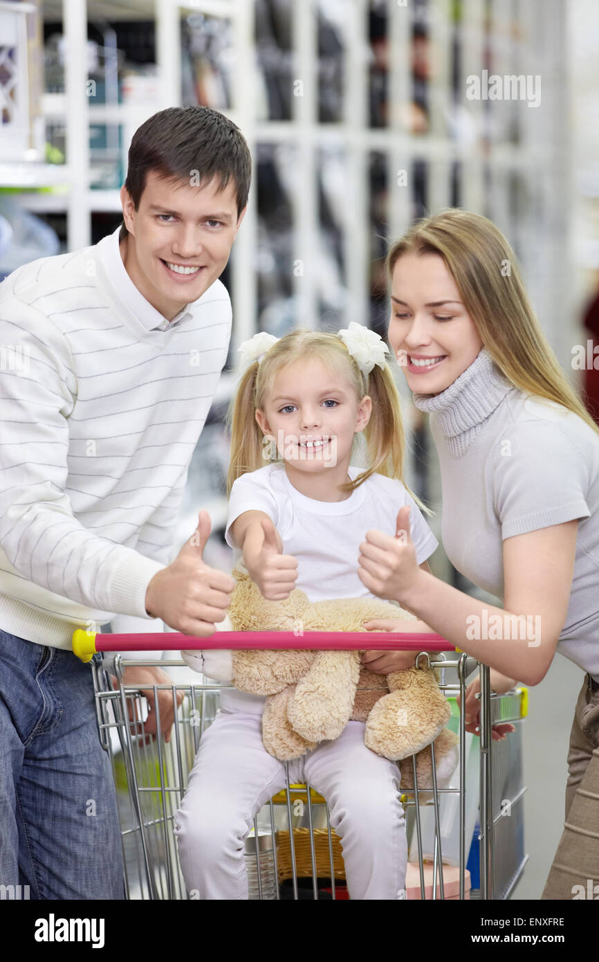 A happy family shows thumbs up at the store Stock Photo - Alamy