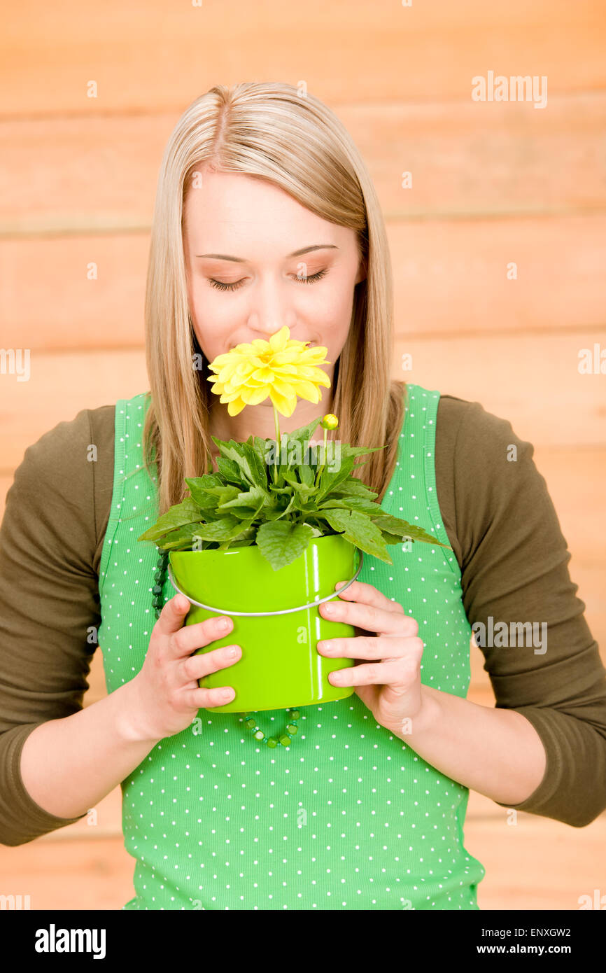 Portrait happy woman smell yellow spring flower Stock Photo - Alamy