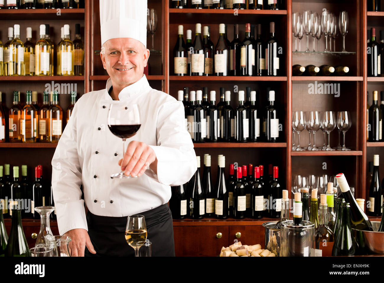 Chef cook smiling serve wine glass restaurant Stock Photo - Alamy