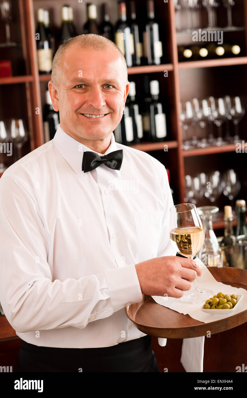 Wine bar waiter mature serve glass restaurant Stock Photo - Alamy