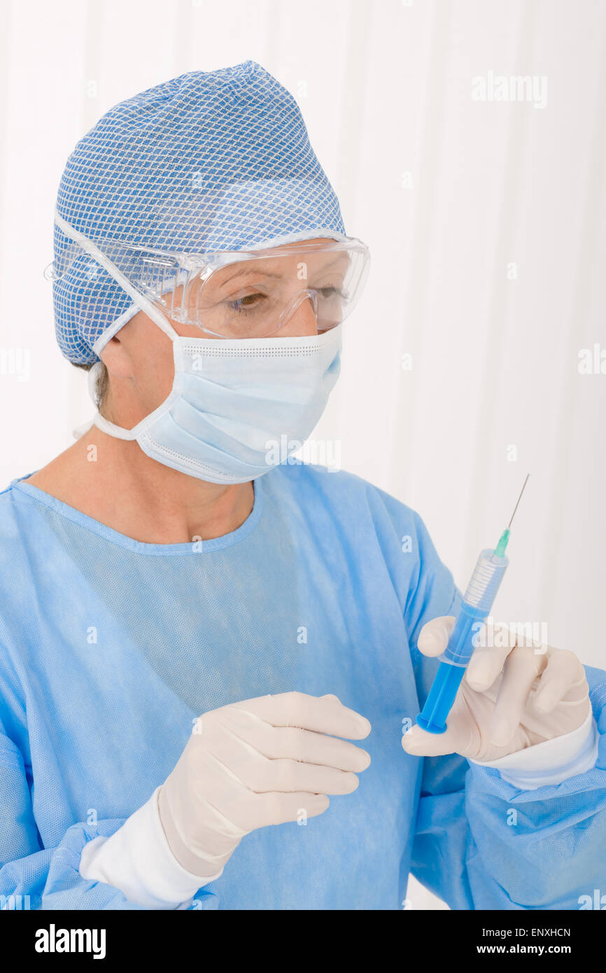Senior surgeon female hold syringe operation wear Stock Photo - Alamy