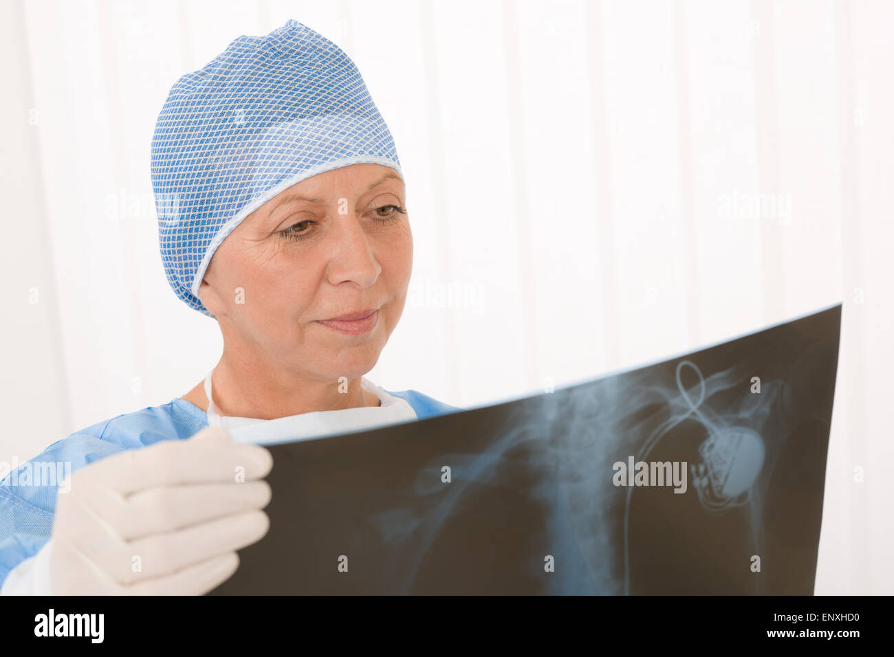 Senior surgeon female hold x-ray protective overall Stock Photo - Alamy