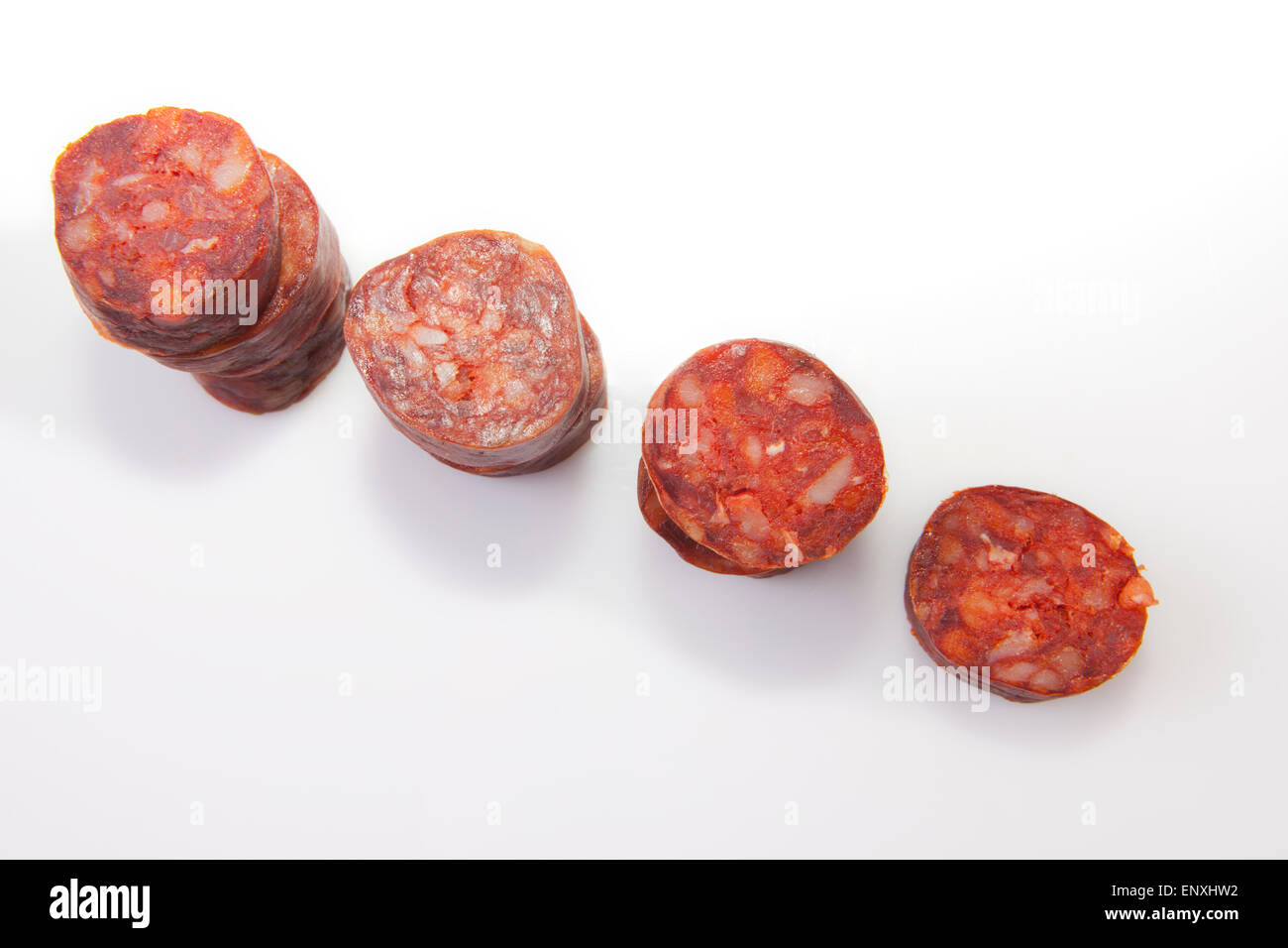 Some cut pieces of red iberian chorizo. Isolated over white background ...