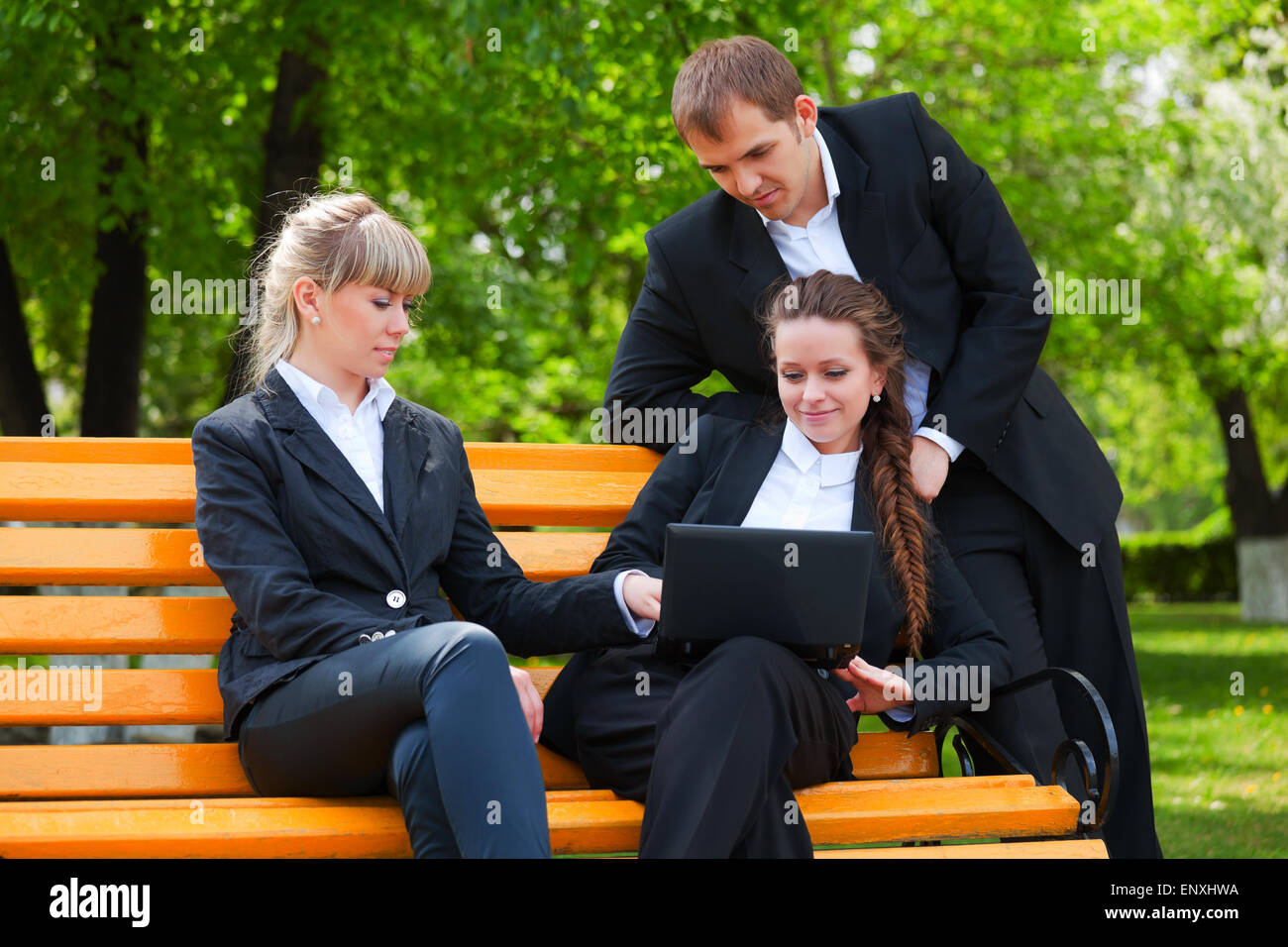 Young business people with laptop in a city park Stock Photo - Alamy